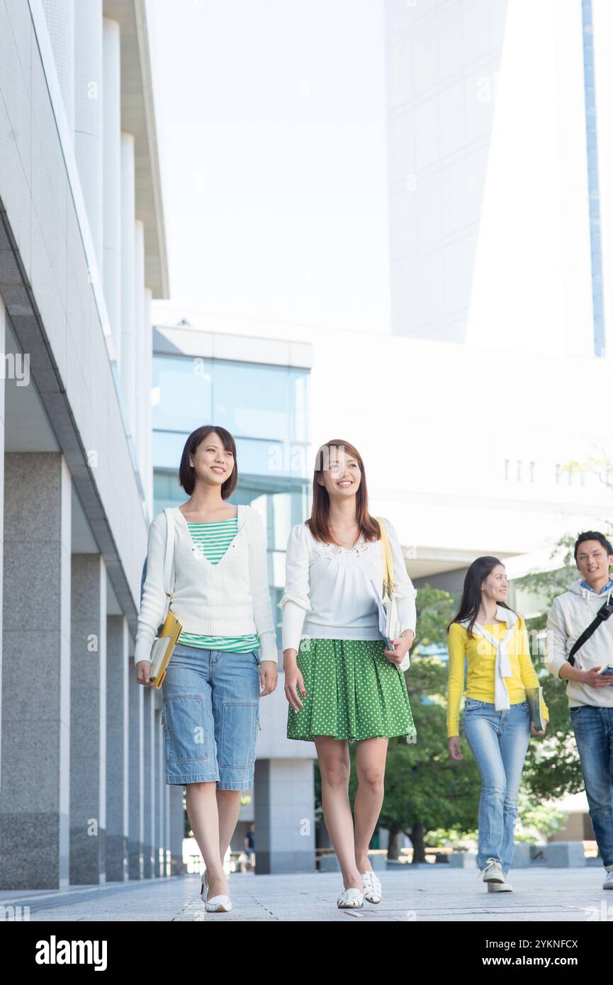 Four university students walking on campus Stock Photo - Alamy