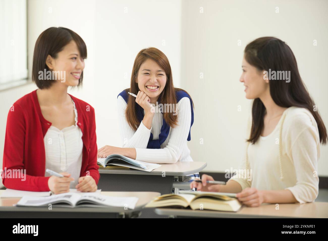 Three female university students studying in a lecture room Stock Photo ...
