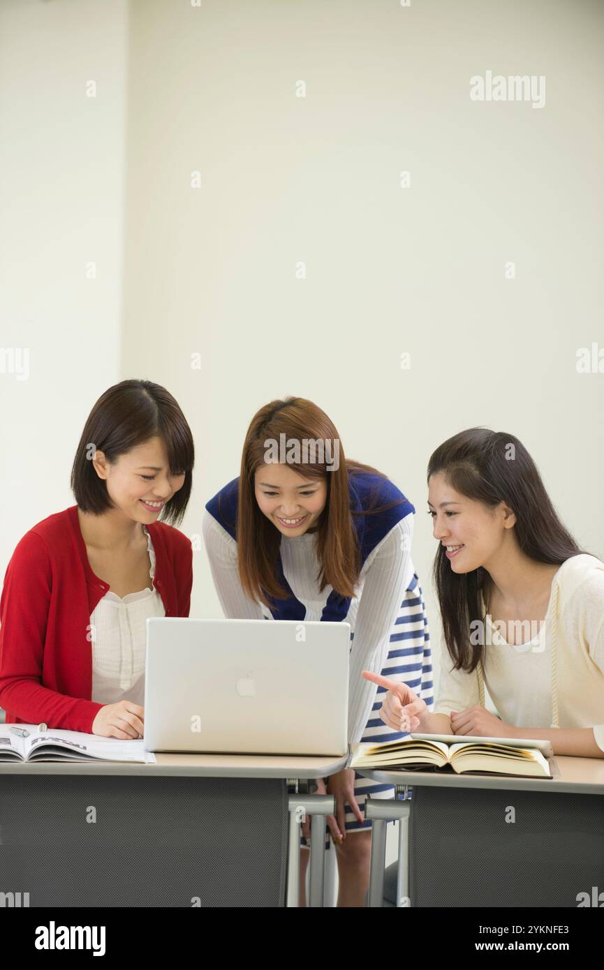 Three female university students studying in a lecture room Stock Photo ...