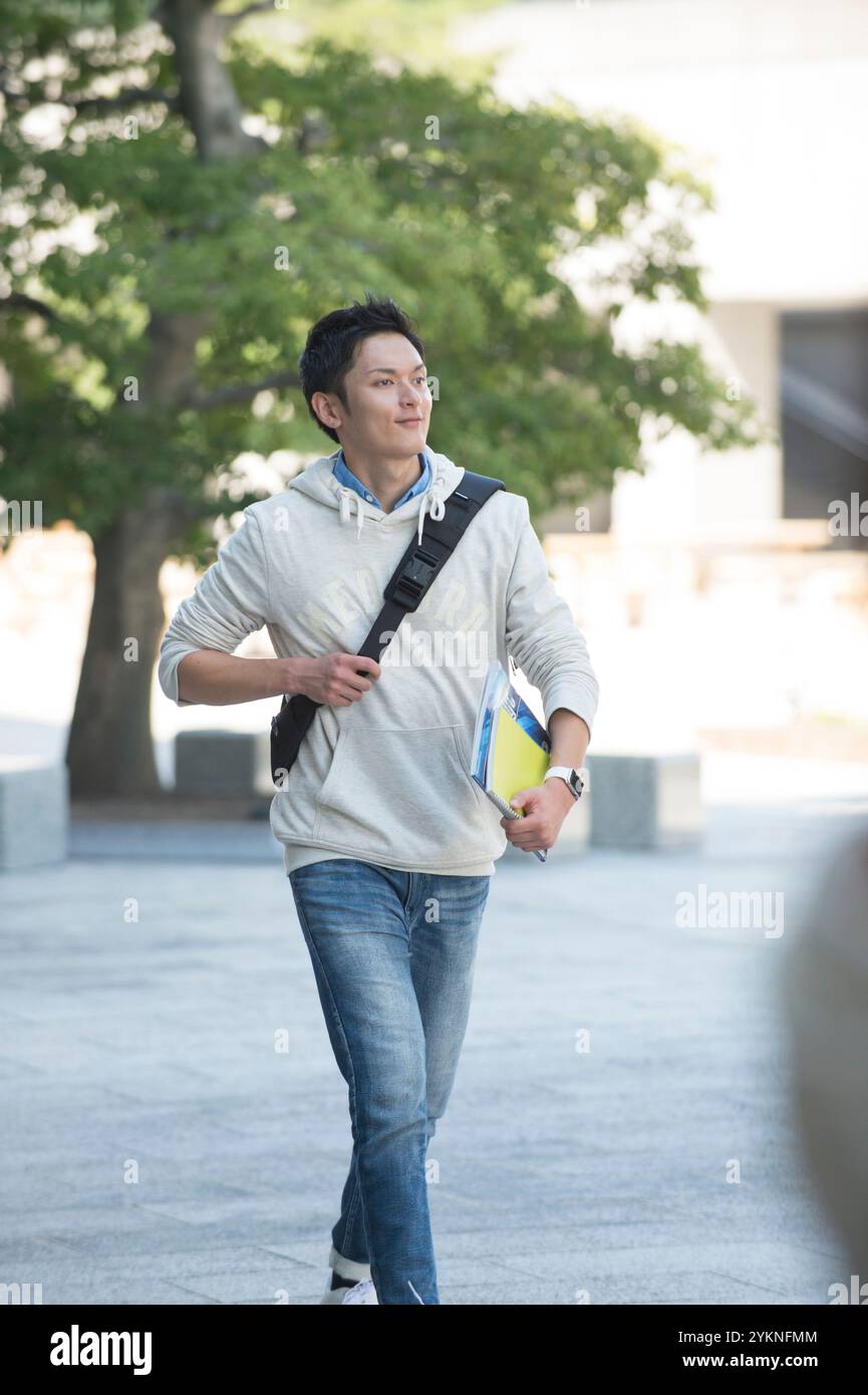 Male university students walking on campus Stock Photo - Alamy