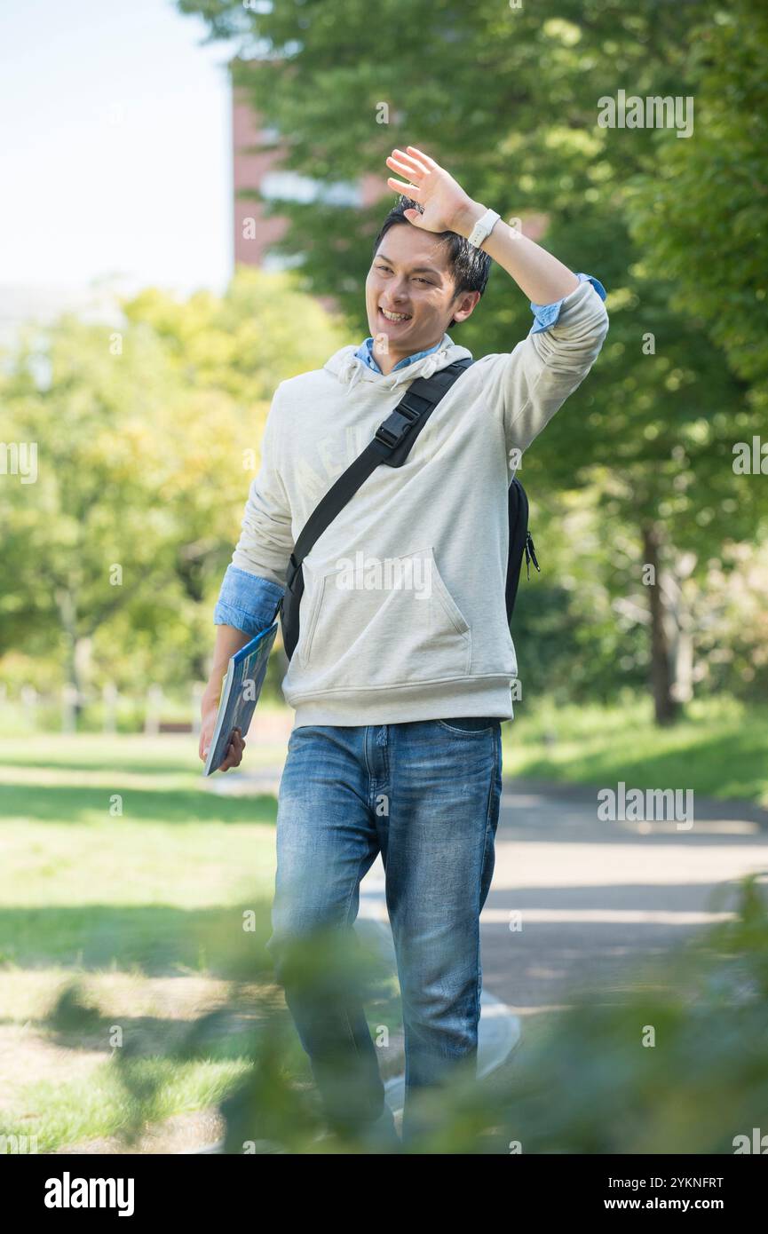 Male university students walking on campus Stock Photo - Alamy