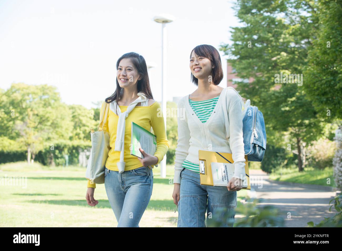 Two female university students walking on campus Stock Photo - Alamy