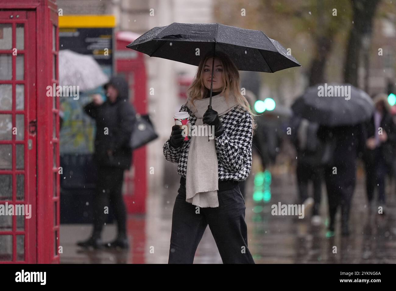 People walking through wintry condition in central, London. The UK is ...