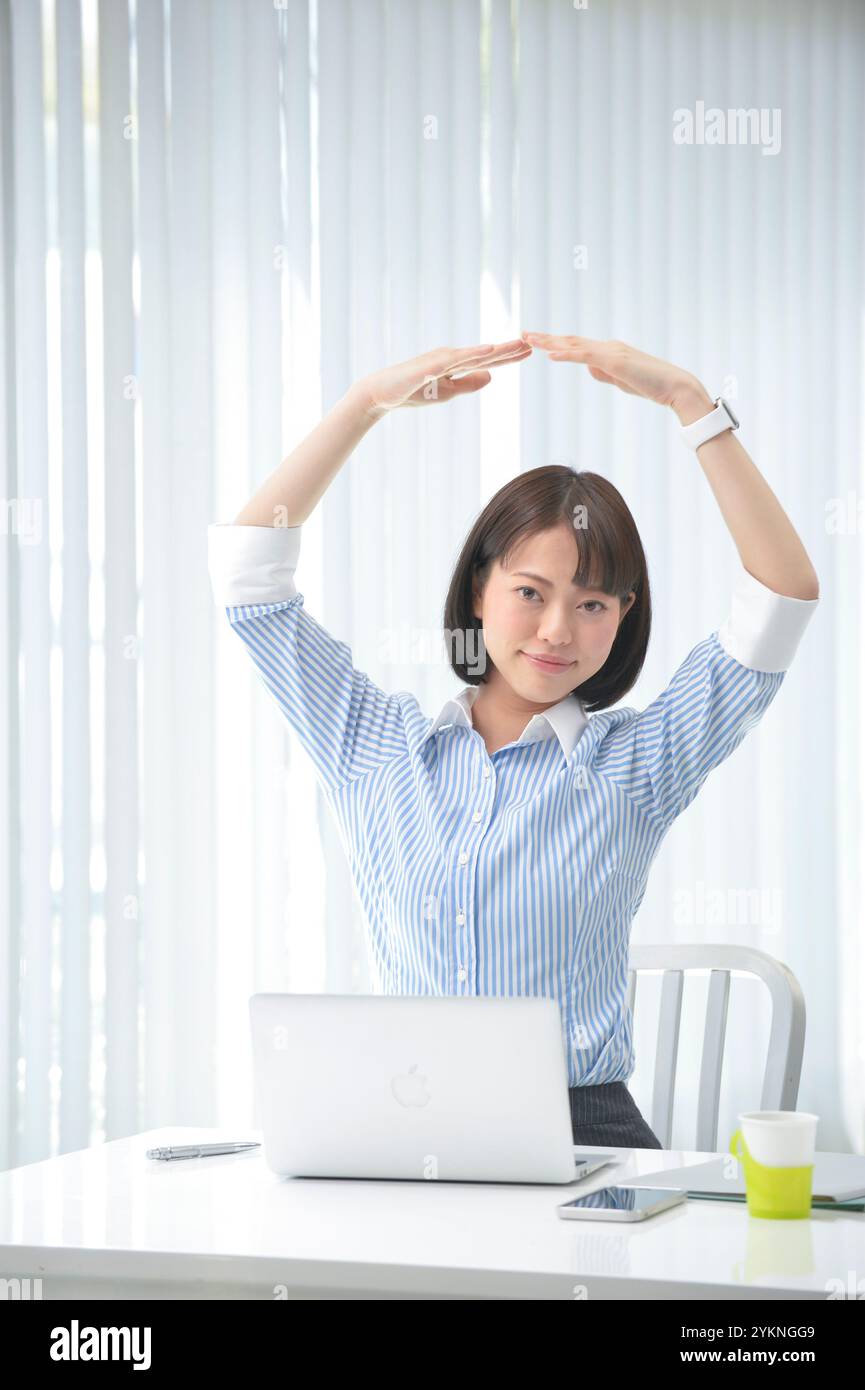 Office worker making a circle with her hand Stock Photo - Alamy