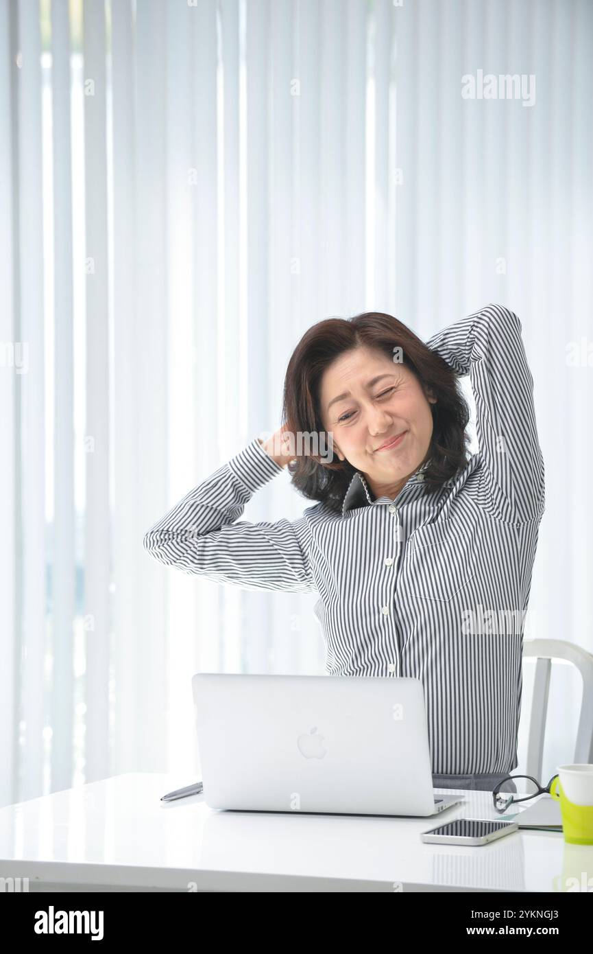 Businesswoman standing tall Stock Photo - Alamy