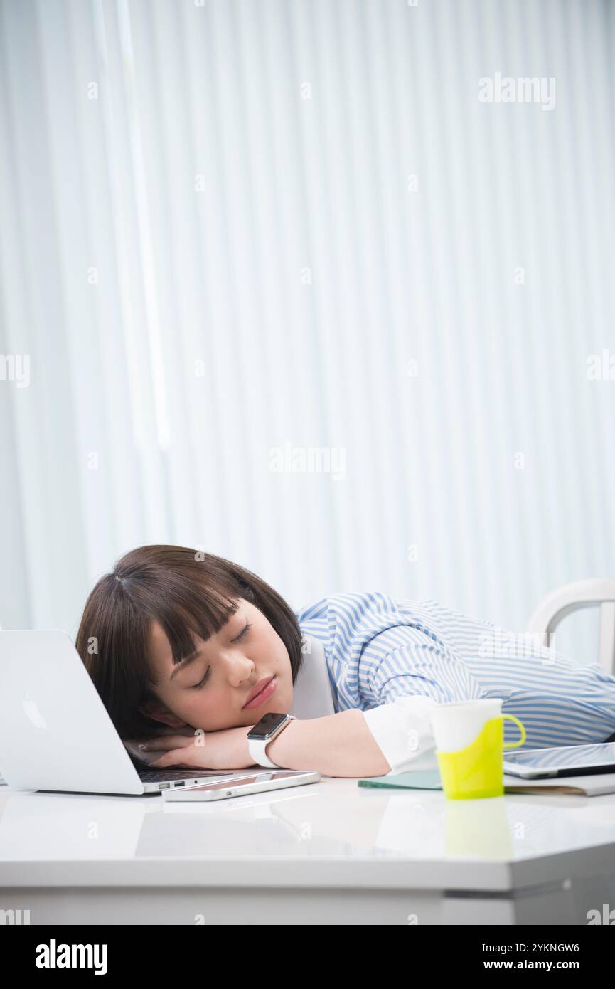 Sleeping office worker at desk Stock Photo - Alamy