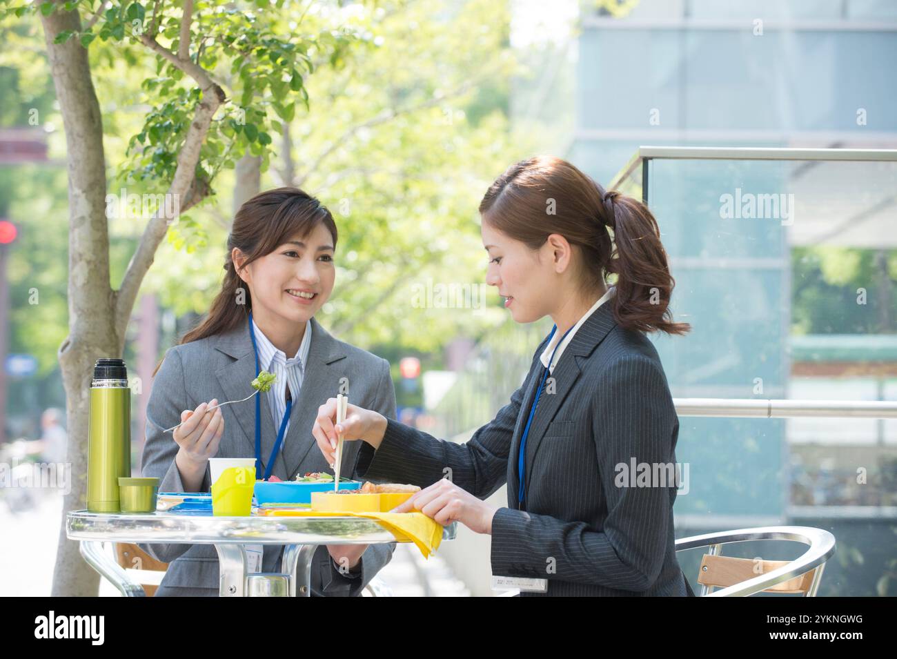 Two office workers eating lunch in office building Stock Photo - Alamy