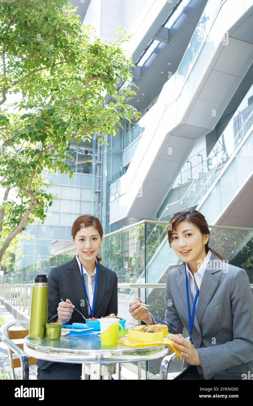 Two office workers eating lunch in office building Stock Photo - Alamy