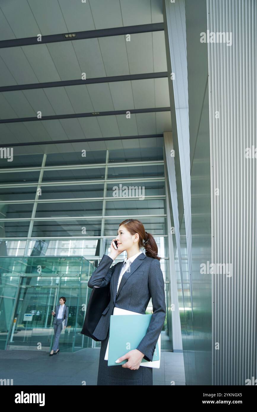 Office worker making a phone call in office building Stock Photo - Alamy