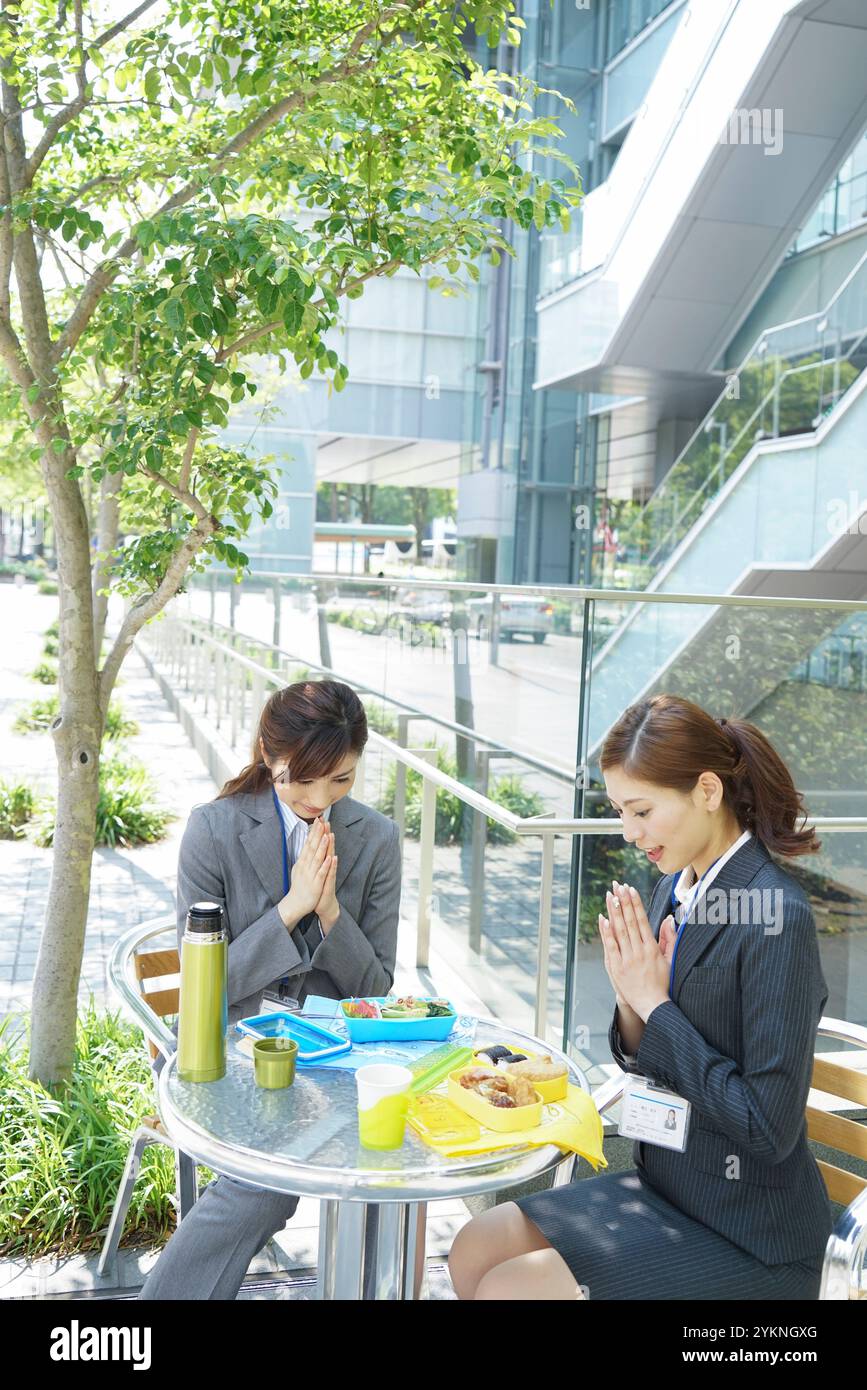 Two office workers eating lunch in office building Stock Photo - Alamy
