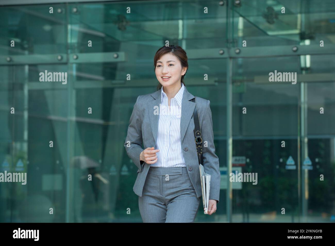 Office worker walking through office building Stock Photo - Alamy