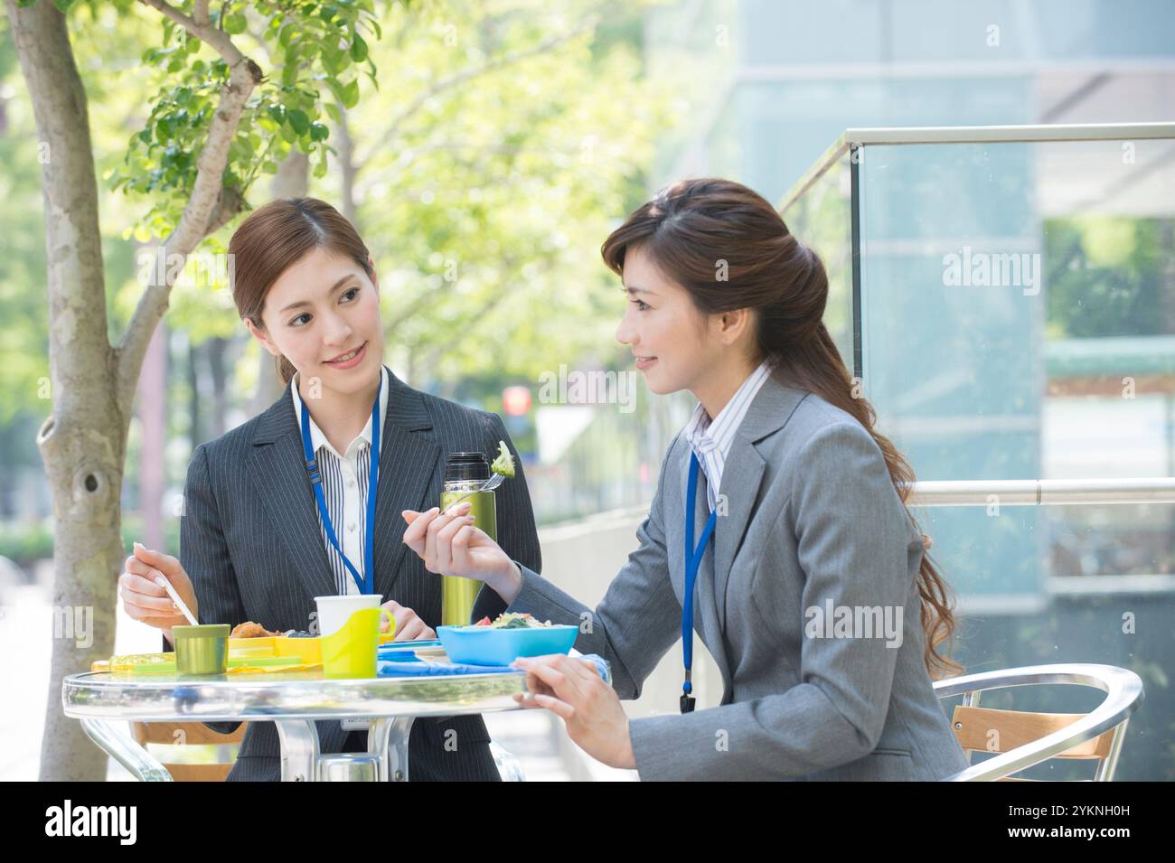 Two office workers eating lunch in office building Stock Photo - Alamy