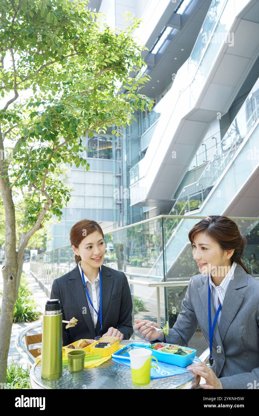 Two office workers eating lunch in office building Stock Photo - Alamy