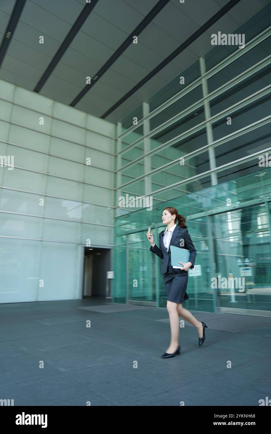Office worker running through office building Stock Photo - Alamy