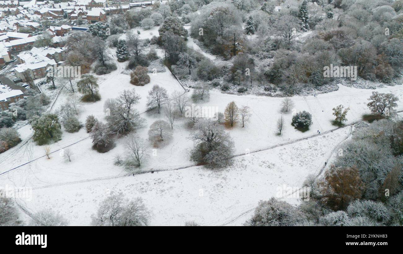 People walk through a snow-covered Priory Park after overnight snowfall ...