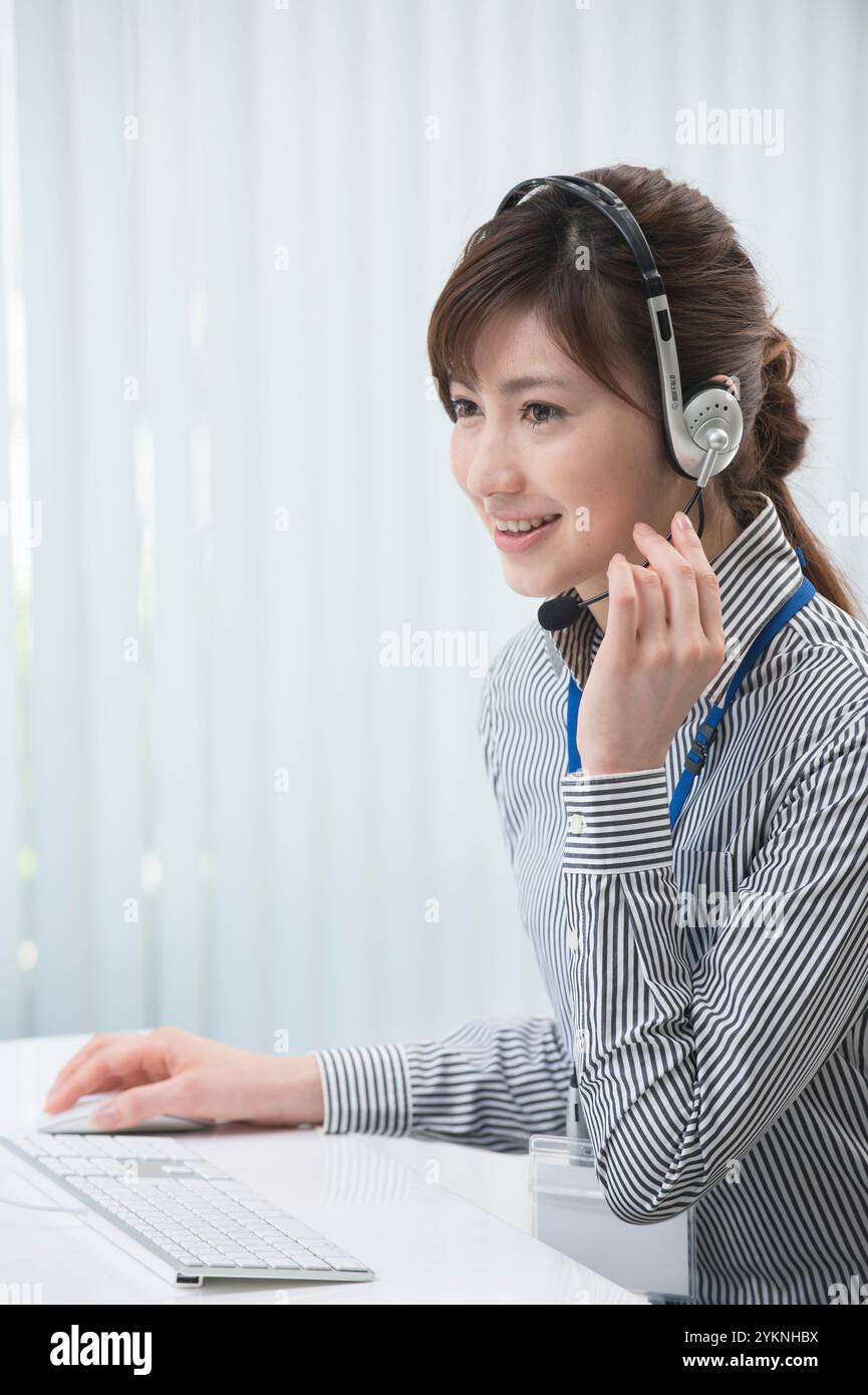 Office worker wearing an intercom Stock Photo - Alamy