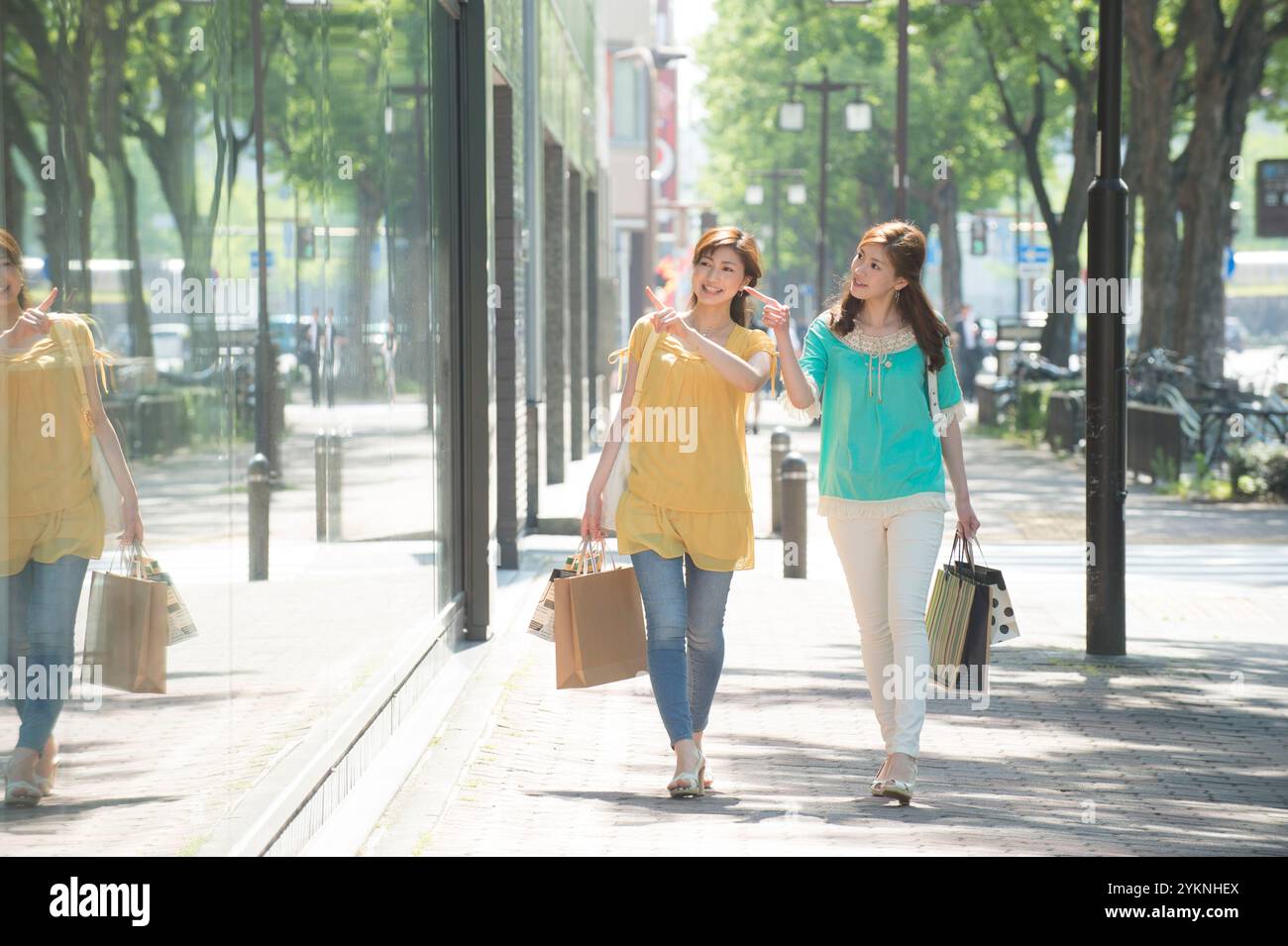 Two women walking through town shopping Stock Photo - Alamy