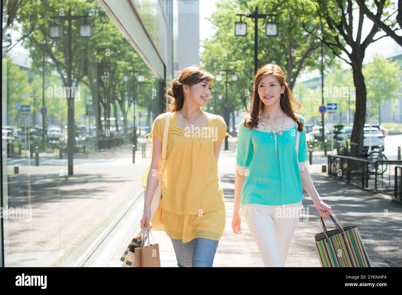 Two women walking through town shopping Stock Photo - Alamy