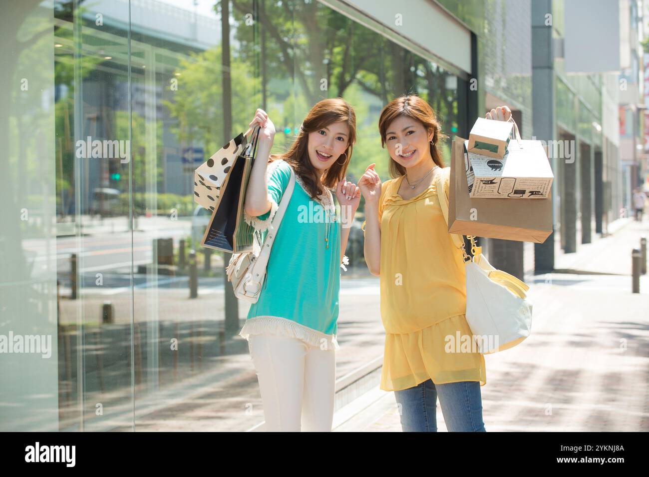 Two women showing their handbags in shopping Stock Photo - Alamy