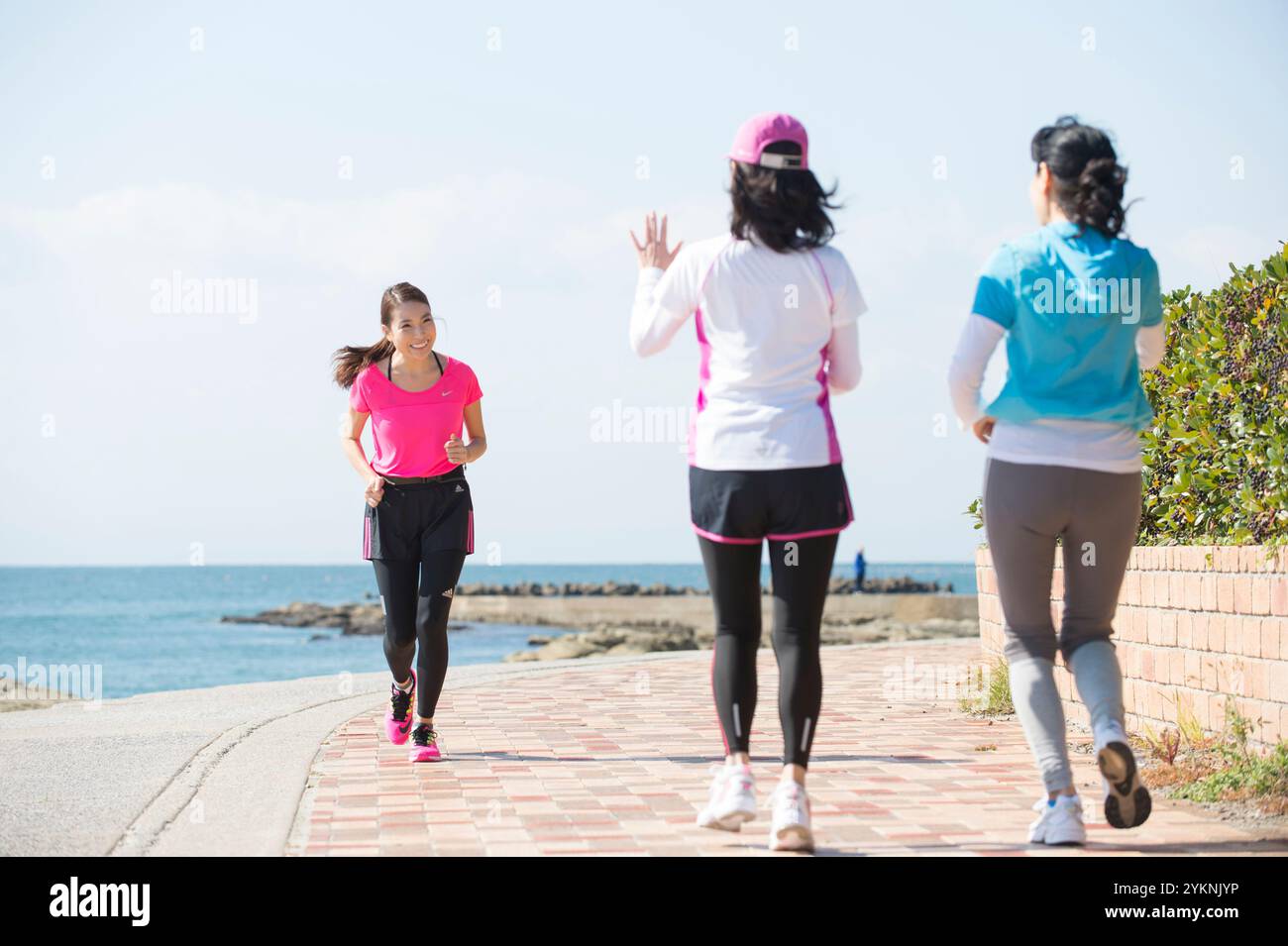 Three women running on the beach Stock Photo - Alamy