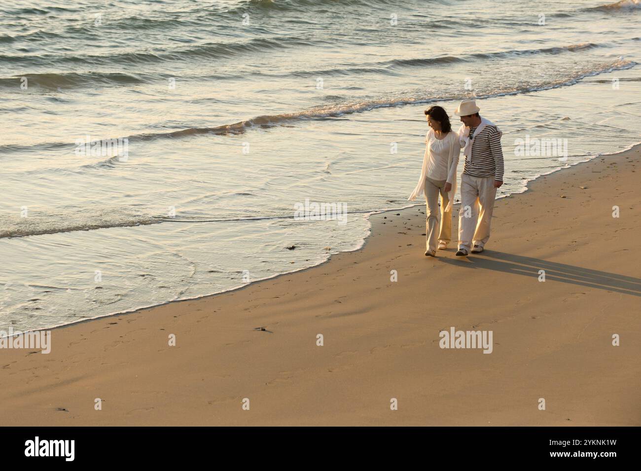 Middle-aged couple strolling on the beach Stock Photo - Alamy