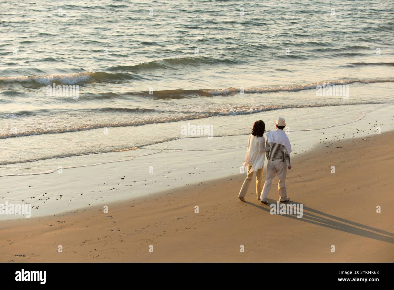 Middle-aged couple strolling on the beach Stock Photo - Alamy