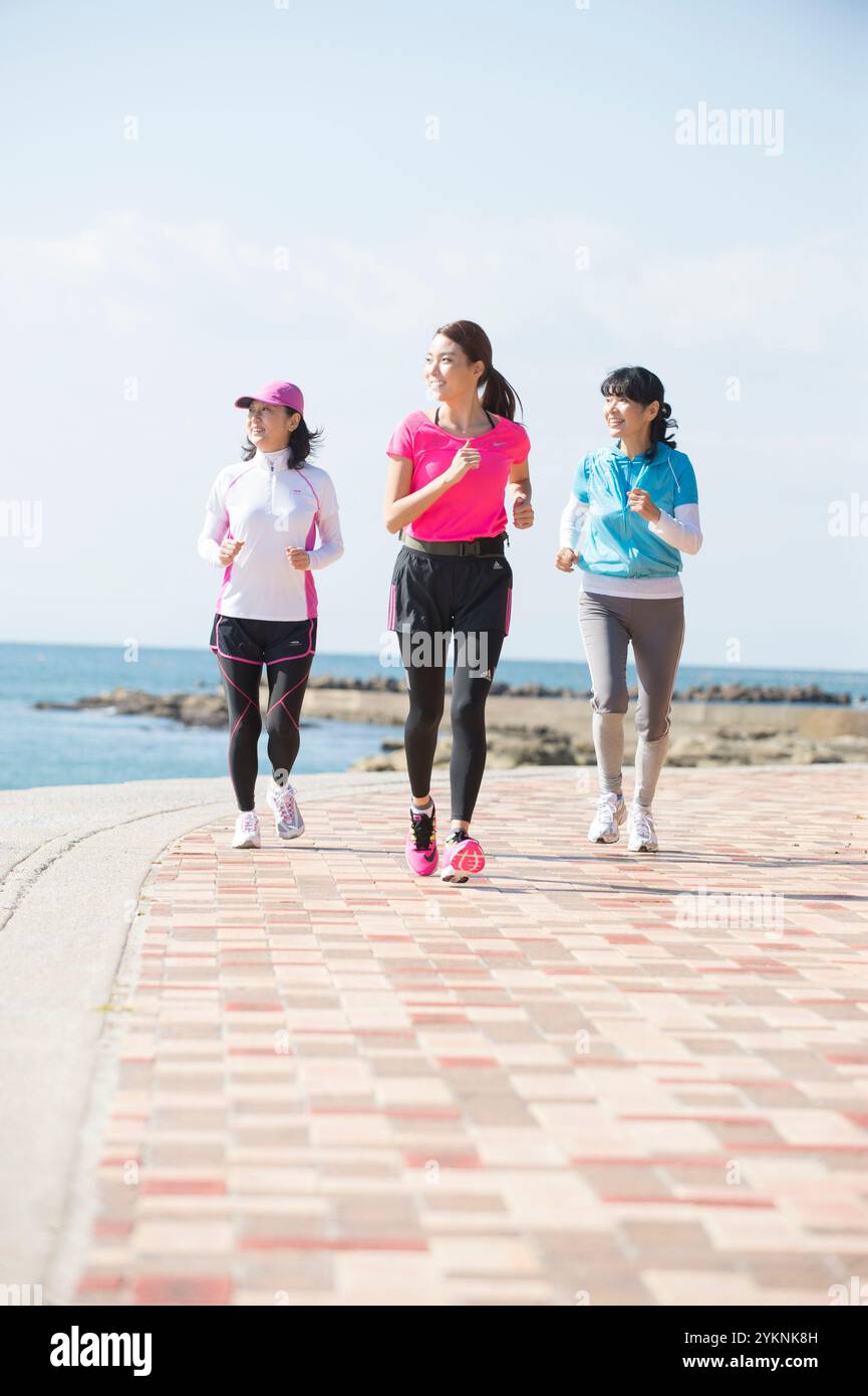 Three women running on hi-res stock photography and images - Alamy