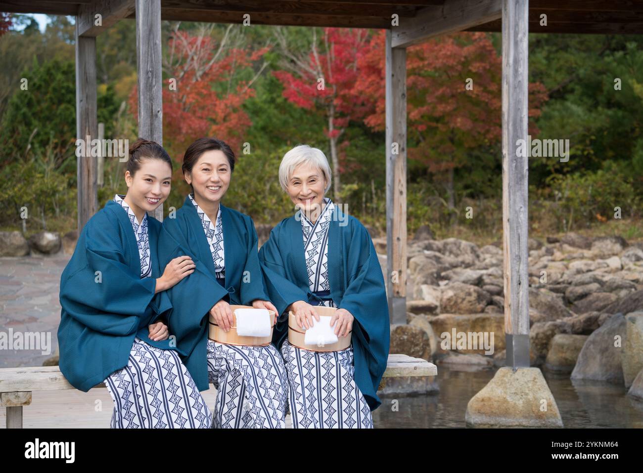 Three generations of parents and children in yukata holding a yukata ...