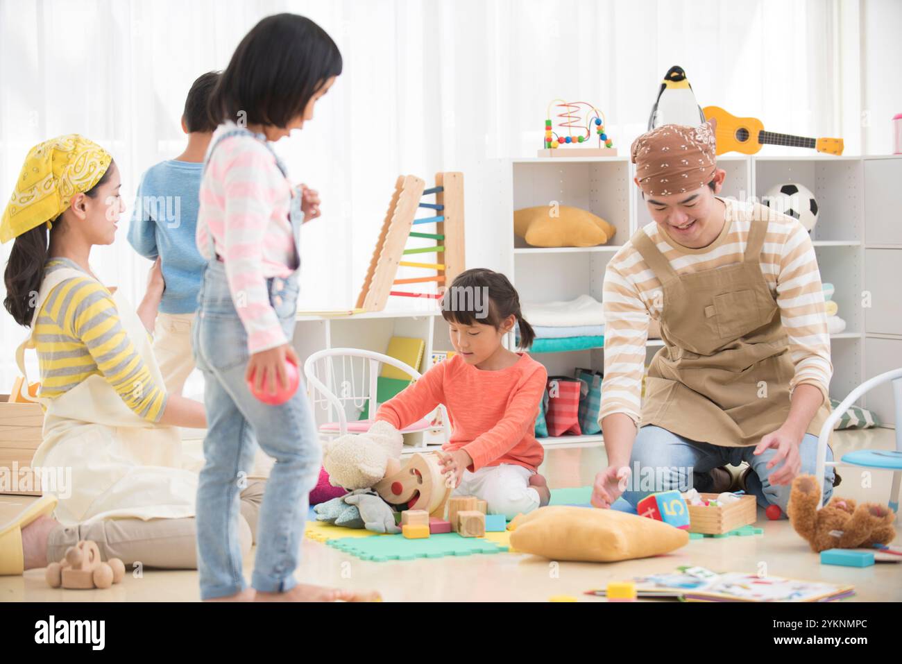 Children playing in a nursery school and nursery staff Stock Photo - Alamy