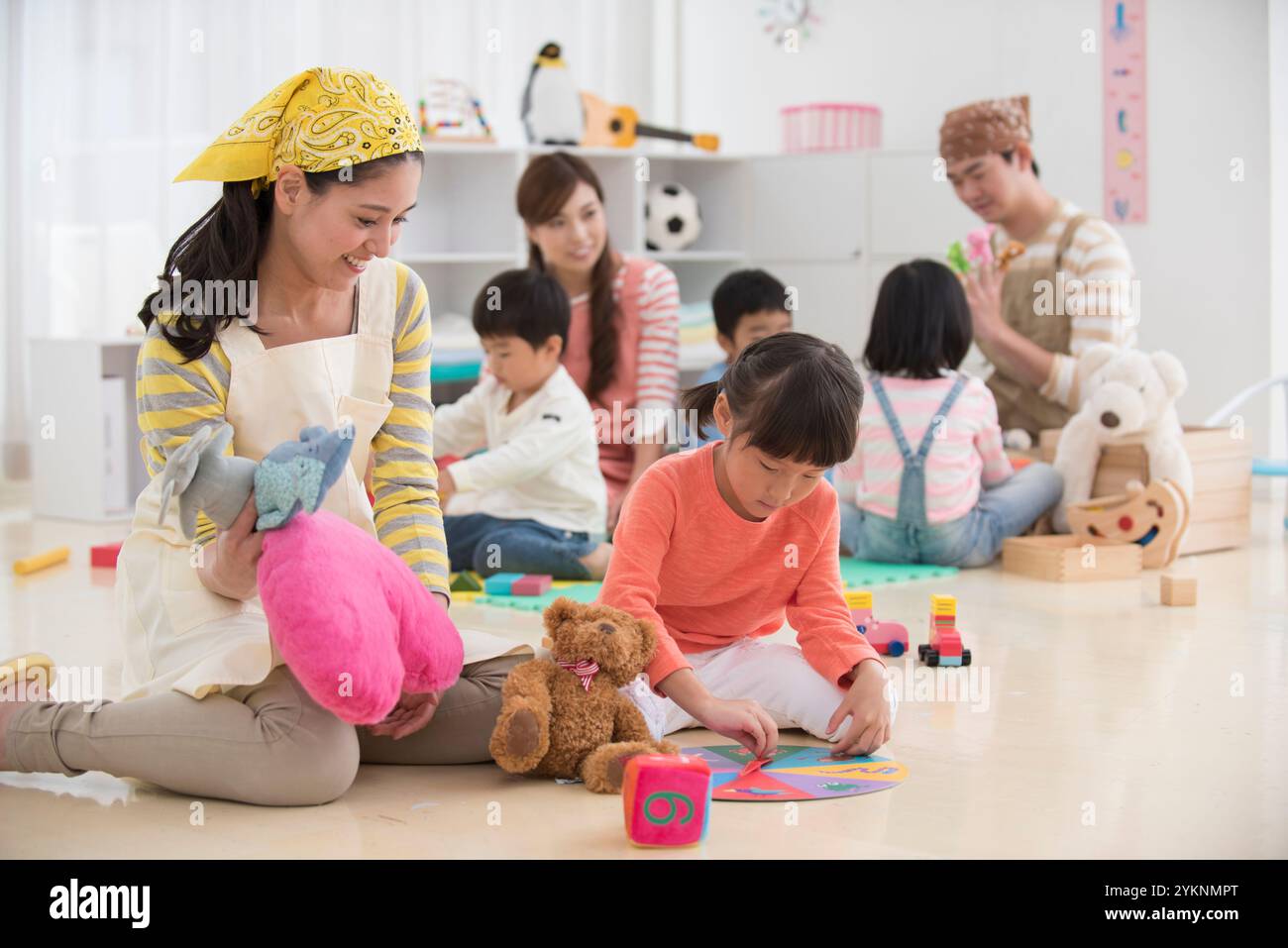 Children playing in a nursery school and nursery staff Stock Photo - Alamy