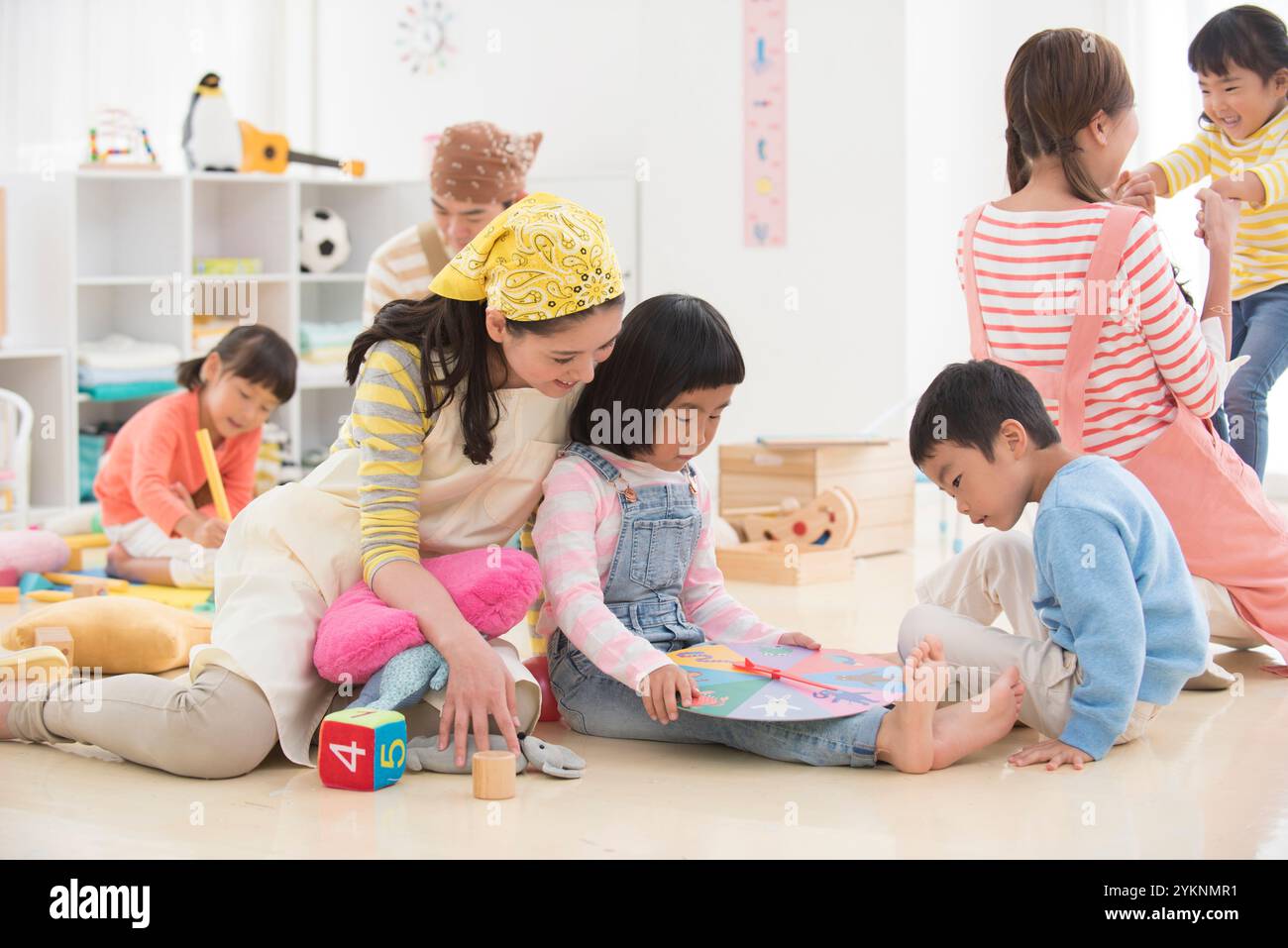 Children playing in a nursery school and nursery staff Stock Photo - Alamy