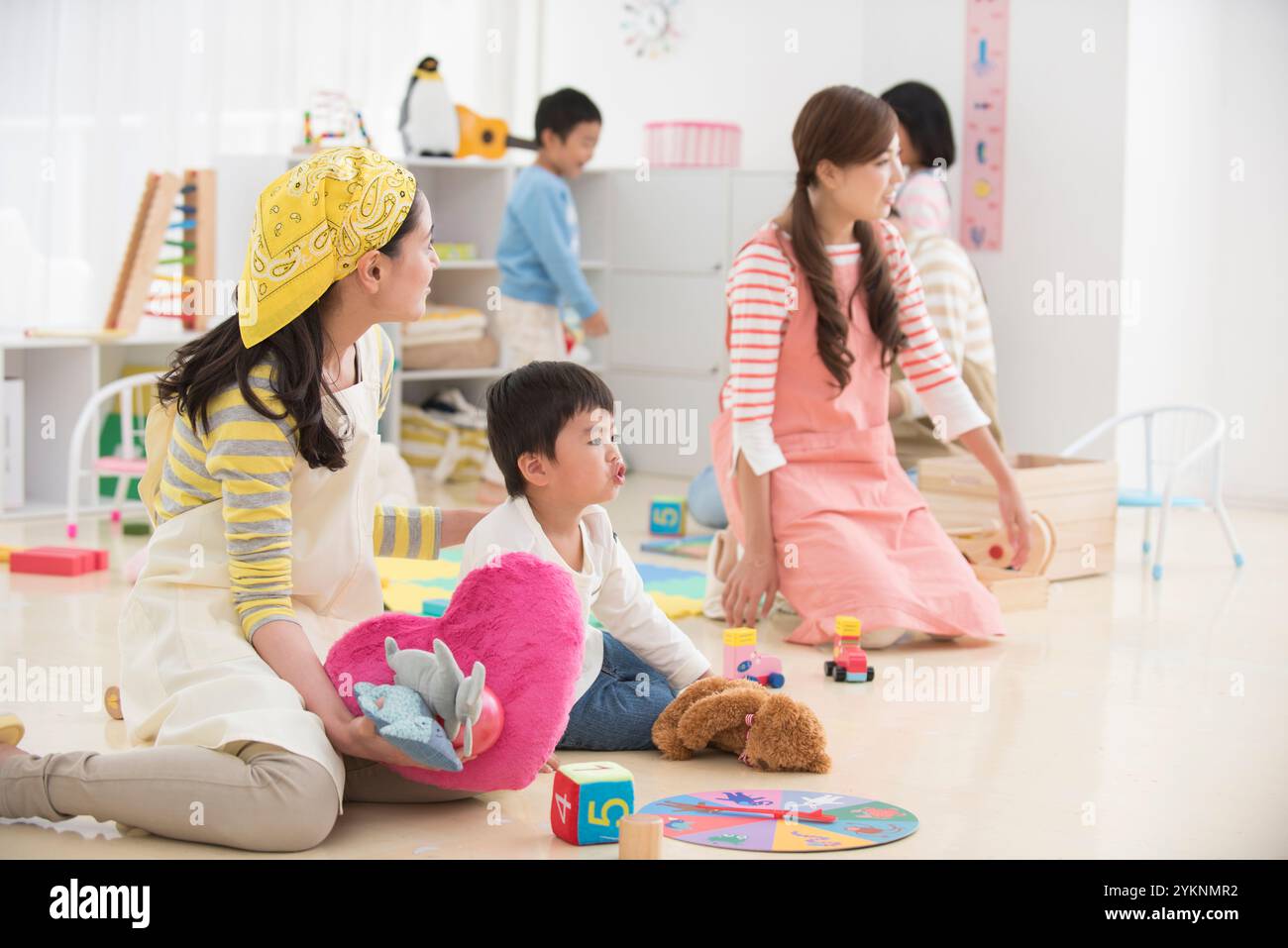 Children playing in a nursery school and nursery staff Stock Photo - Alamy