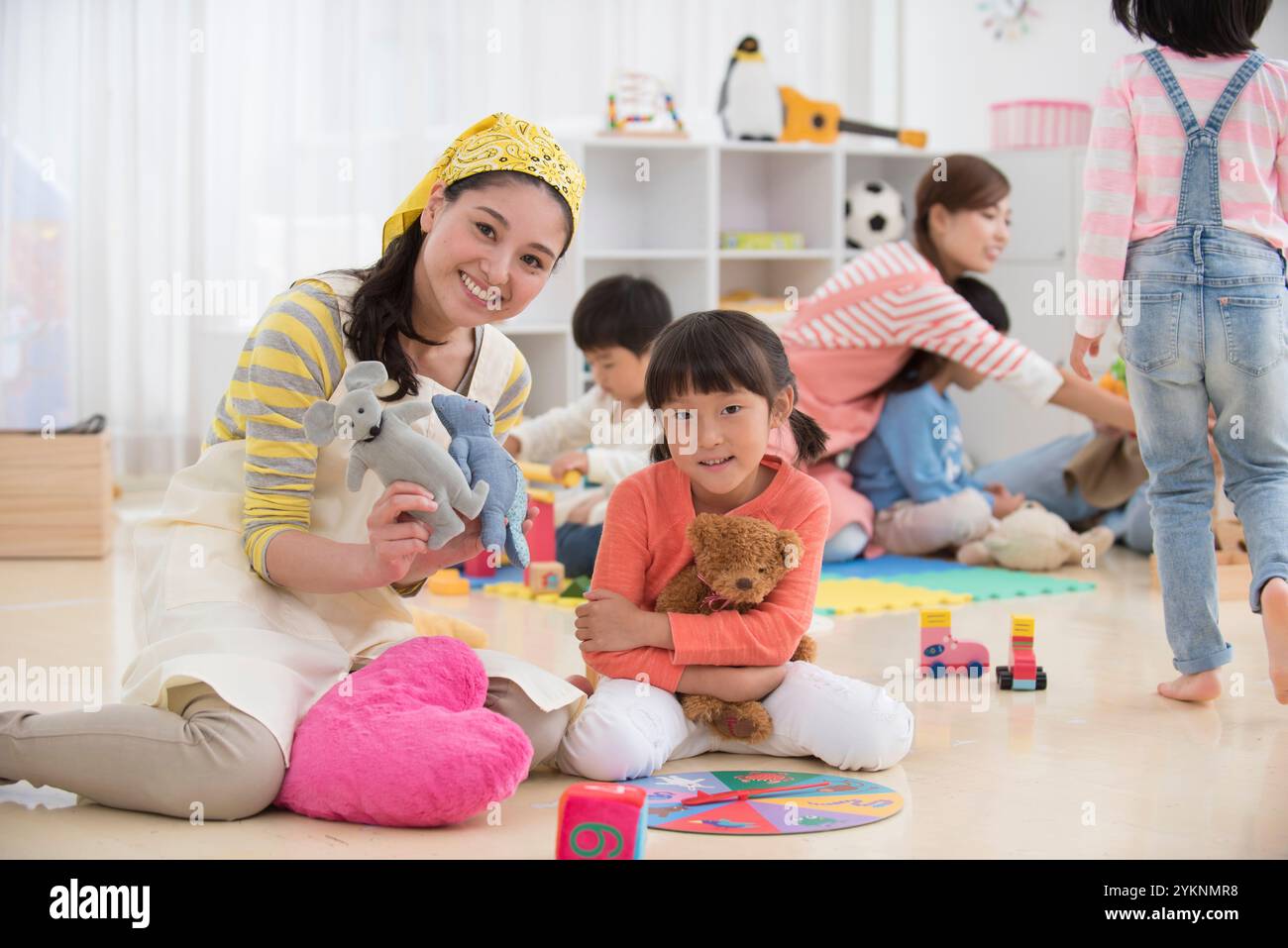 Children playing in a nursery school and nursery staff Stock Photo - Alamy