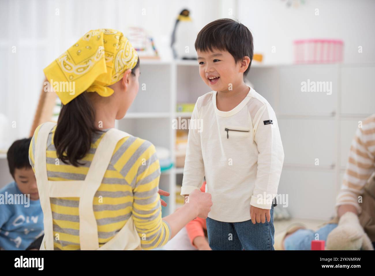Children playing in a nursery school and nursery staff Stock Photo - Alamy