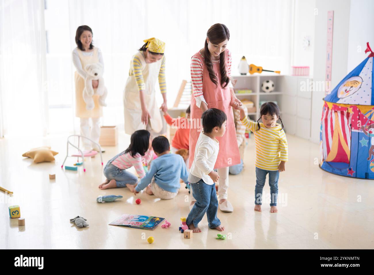 Children playing in a nursery school and nursery staff Stock Photo - Alamy