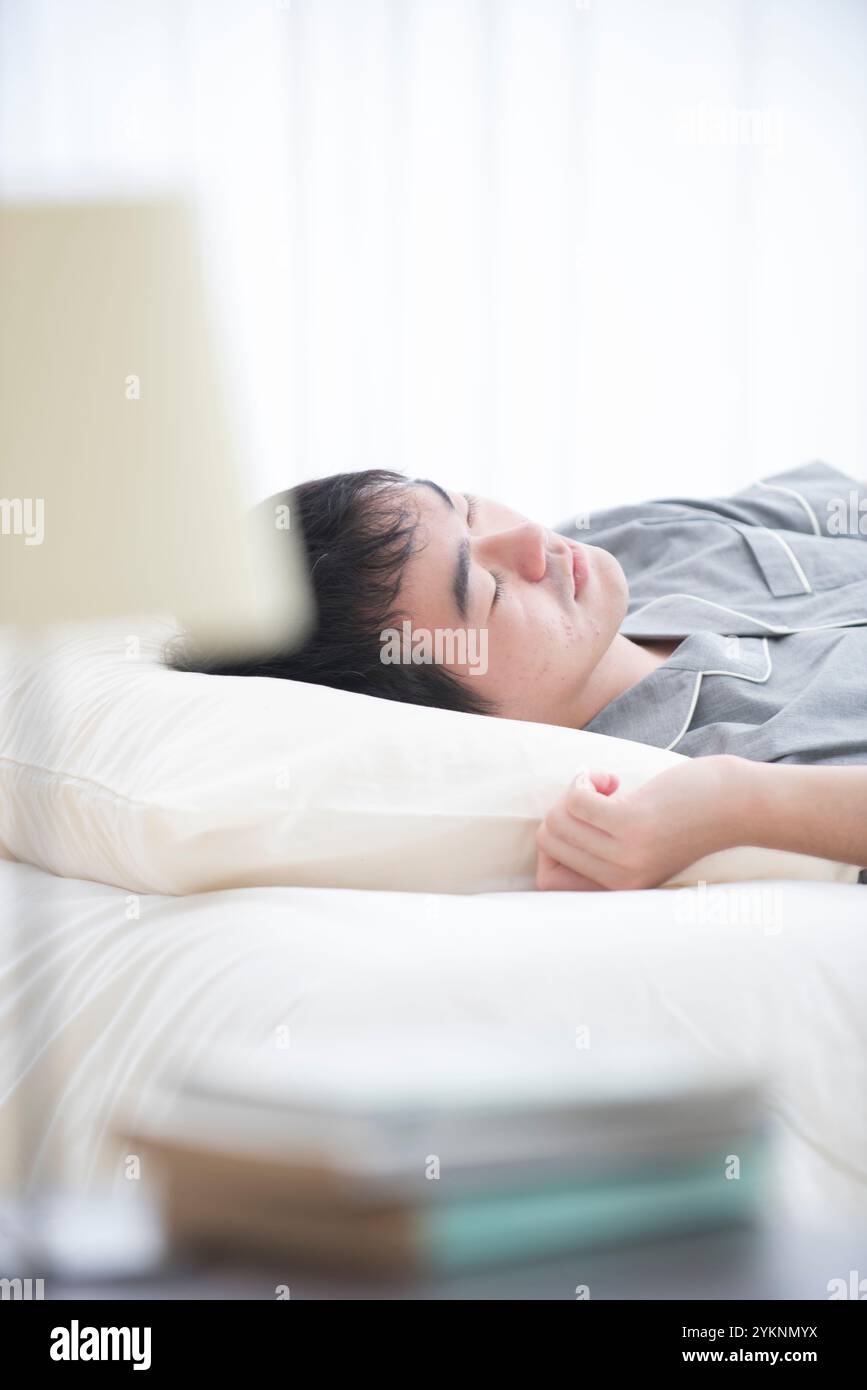 Men sleeping in bed Stock Photo - Alamy