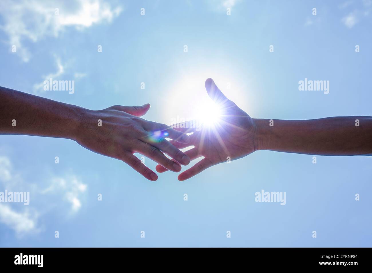 Blue sky, the sun and two outstretched hands Stock Photo - Alamy