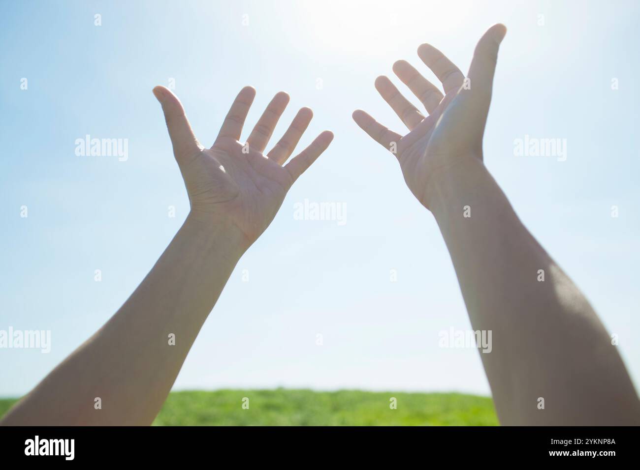 The sun and an outstretched hand in the sky Stock Photo - Alamy