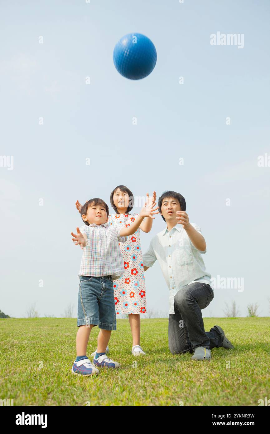 Parent and child playing with ball Stock Photo - Alamy