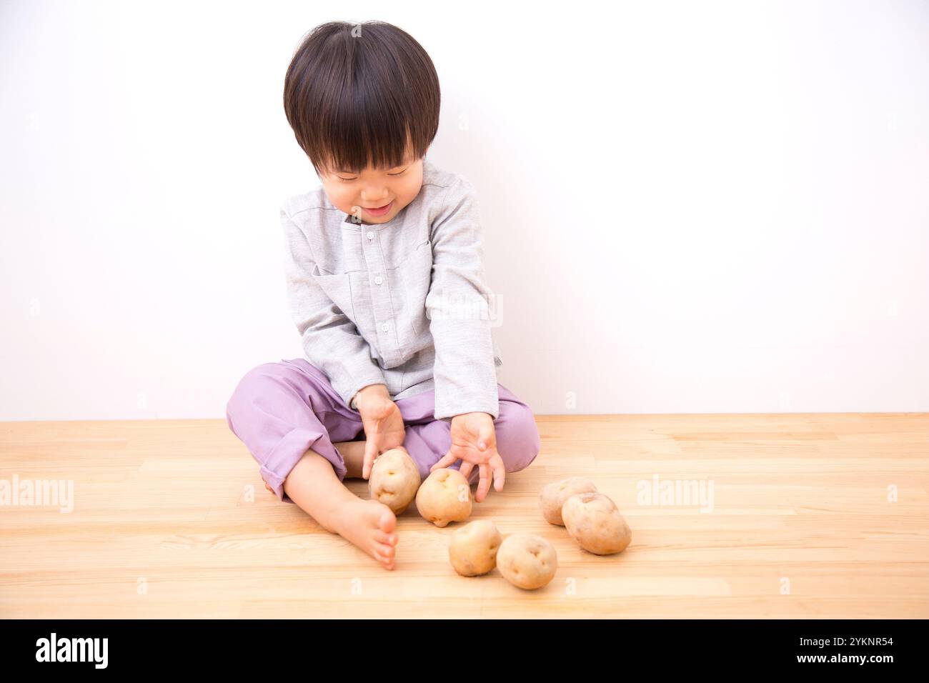 Boy holding potato Stock Photo - Alamy