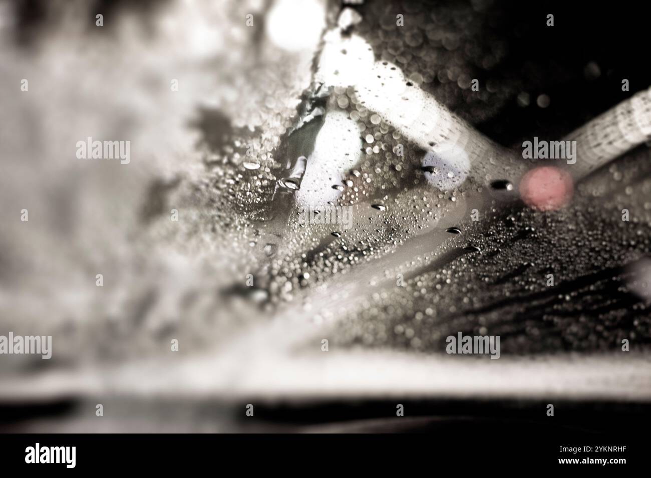 Photograph of a view from a car window through raindrops in a motorway ...