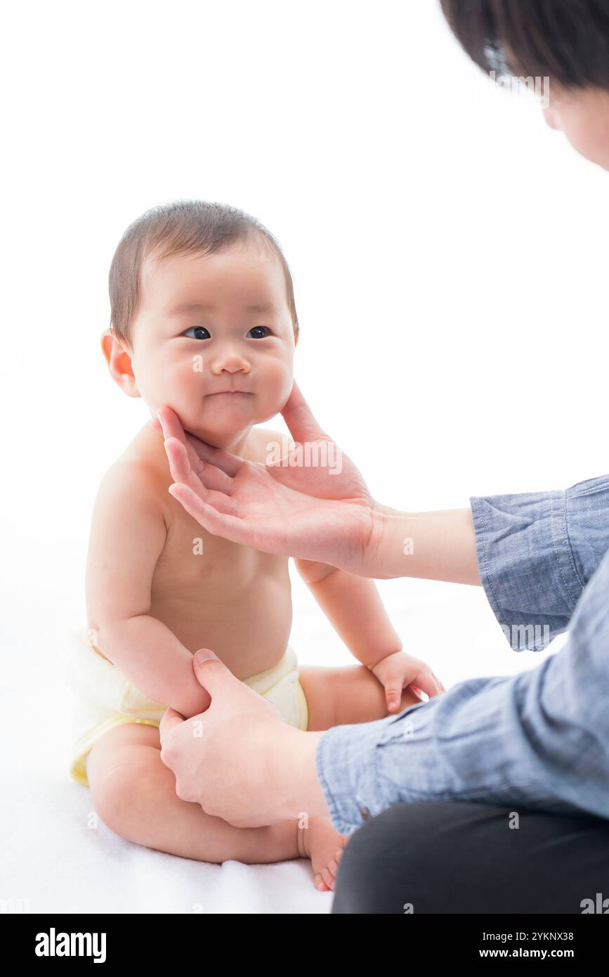 Baby being touched in the face by daddy Stock Photo - Alamy