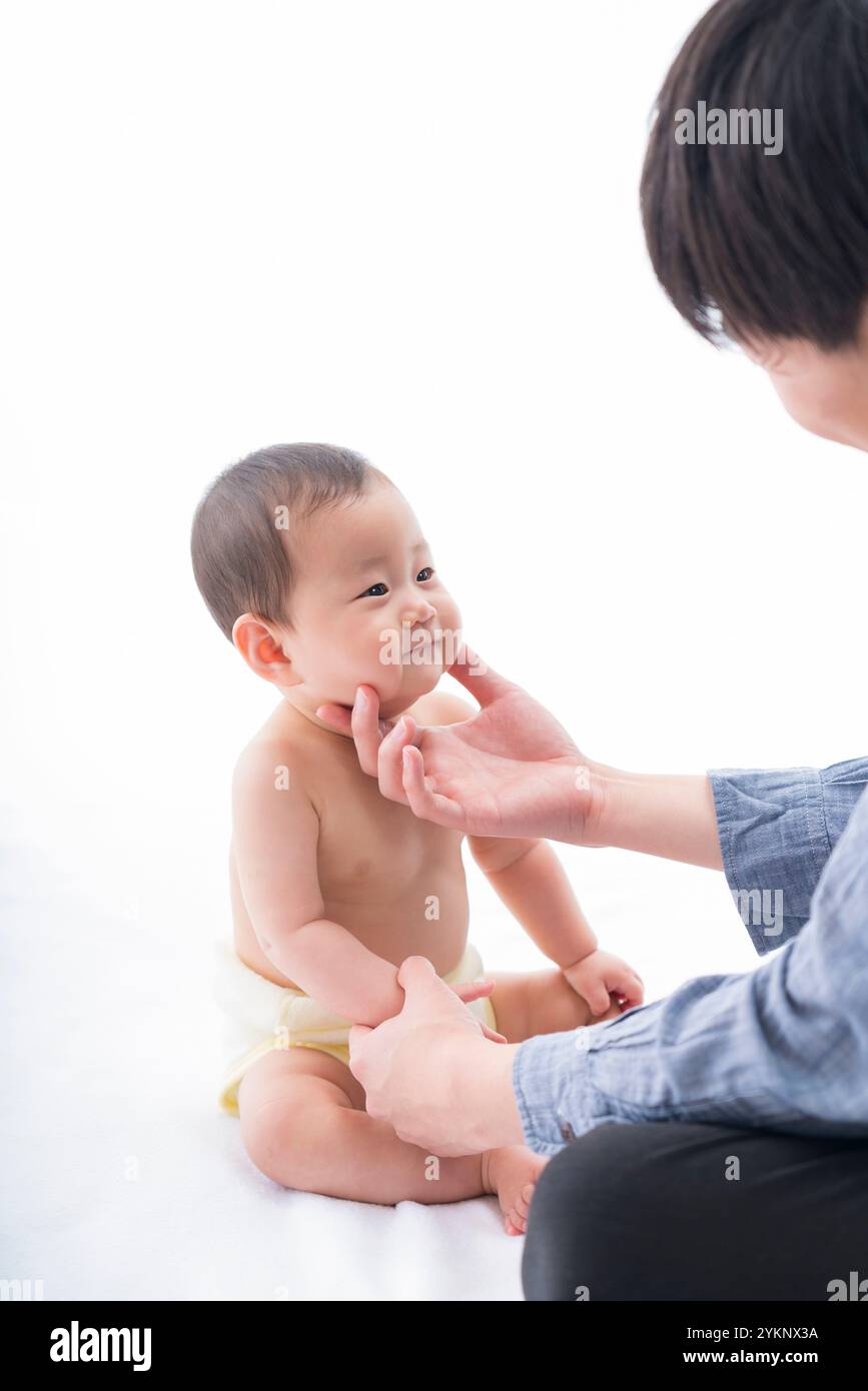 Baby being touched on the face by daddy Stock Photo - Alamy