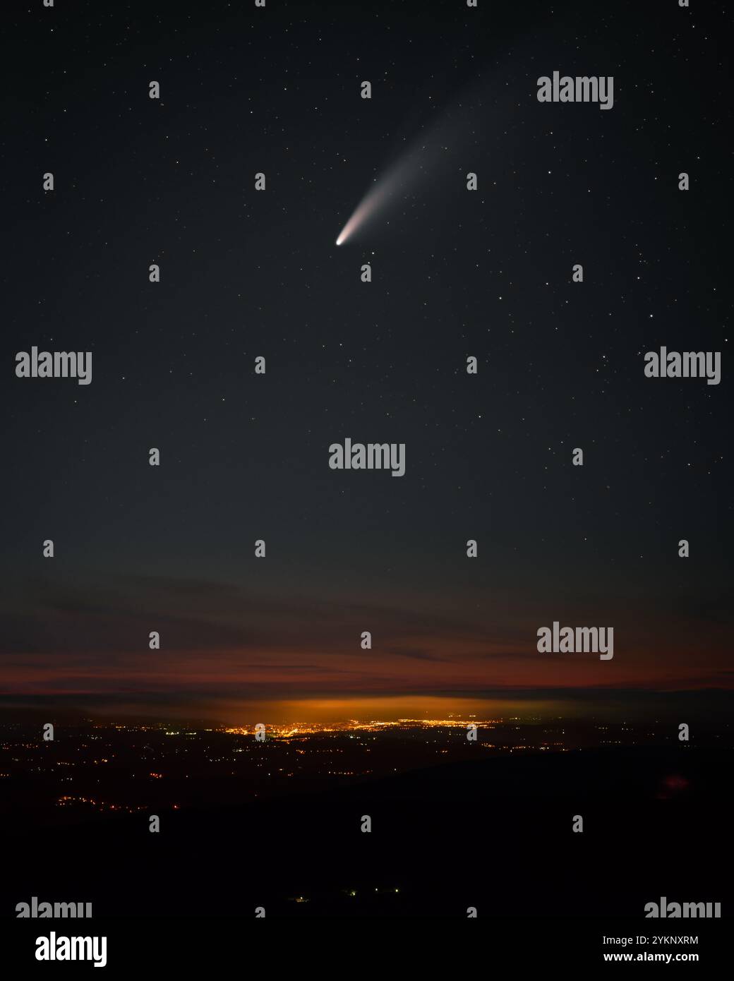 A comet lights up the night sky shortly after sunset over an ... A comet lights up the night sky shortly after sunset over an ...