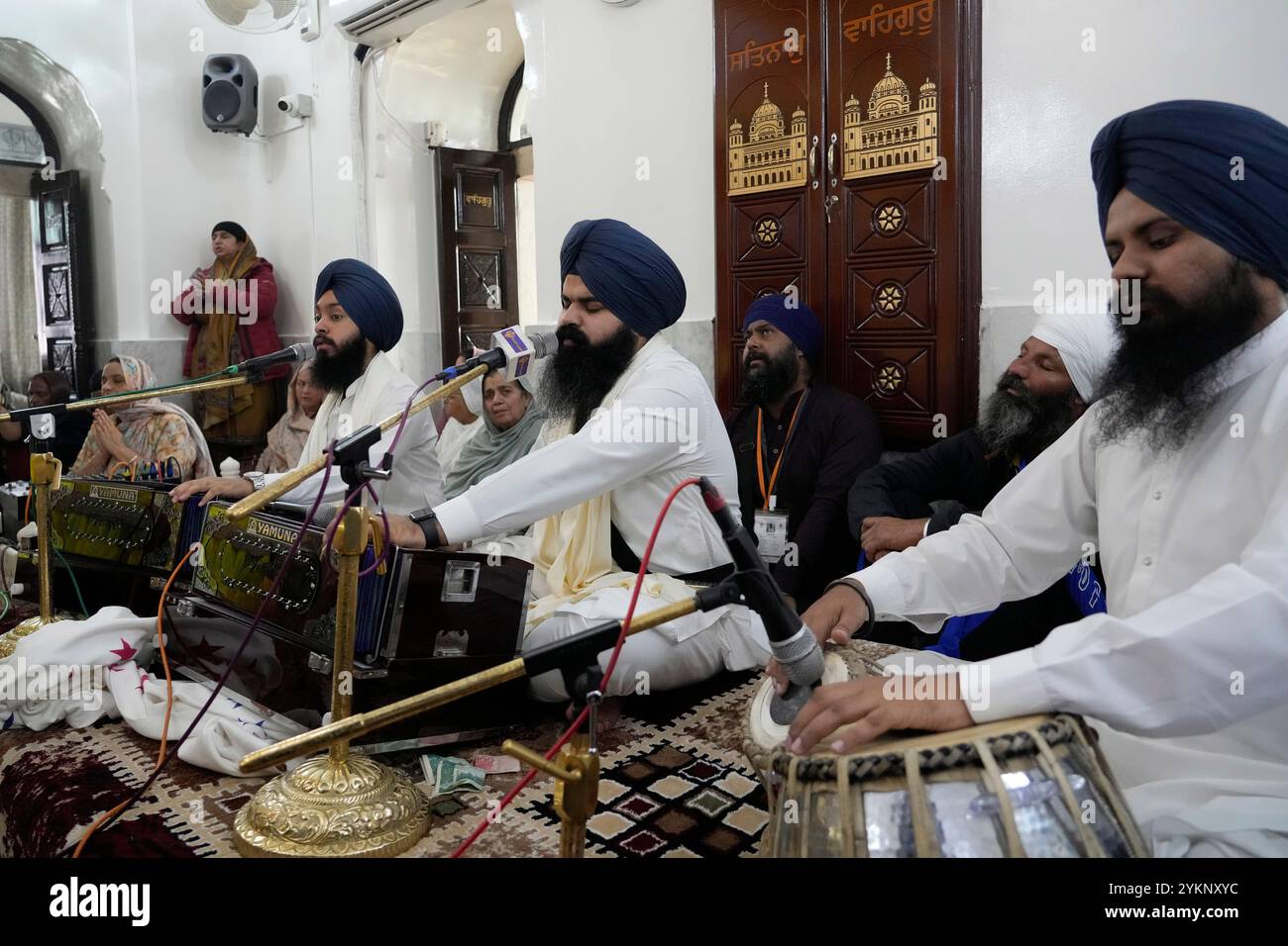 A group of Sikh pilgrims sing religious songs as they attend their ...