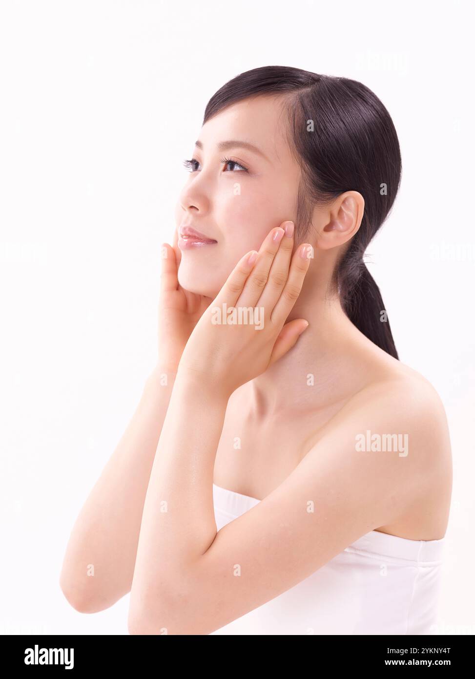 Woman with hand on cheek taking care of skin Stock Photo - Alamy