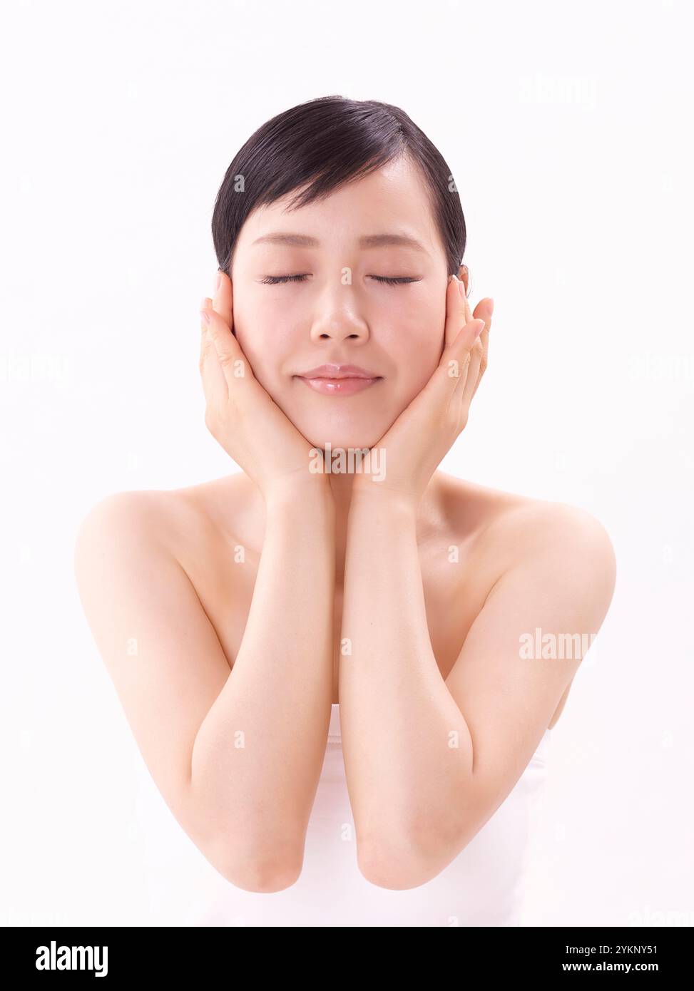 Woman with hand on cheek taking care of skin Stock Photo - Alamy