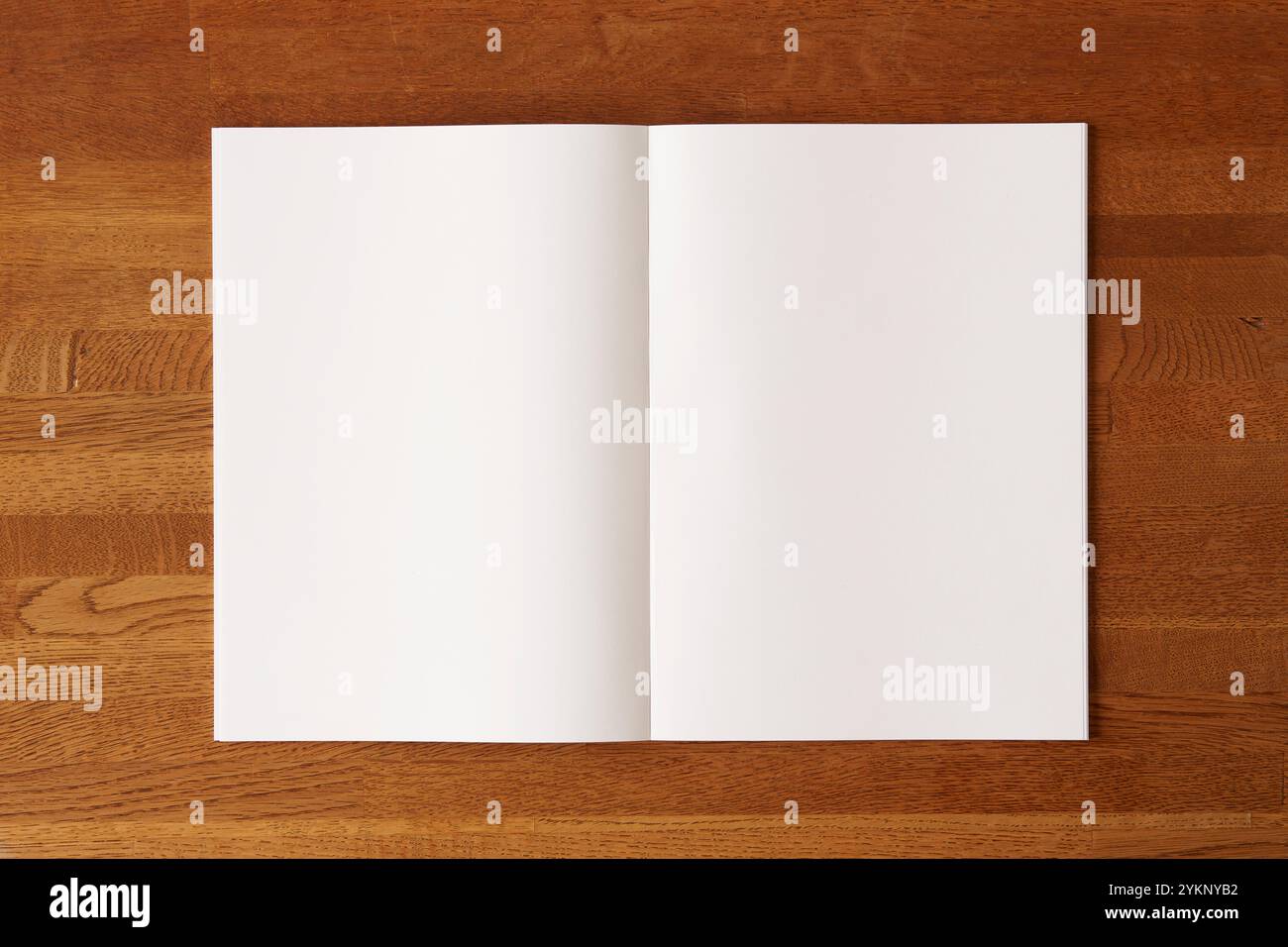 Wooden desk and open white plain notebook Stock Photo - Alamy