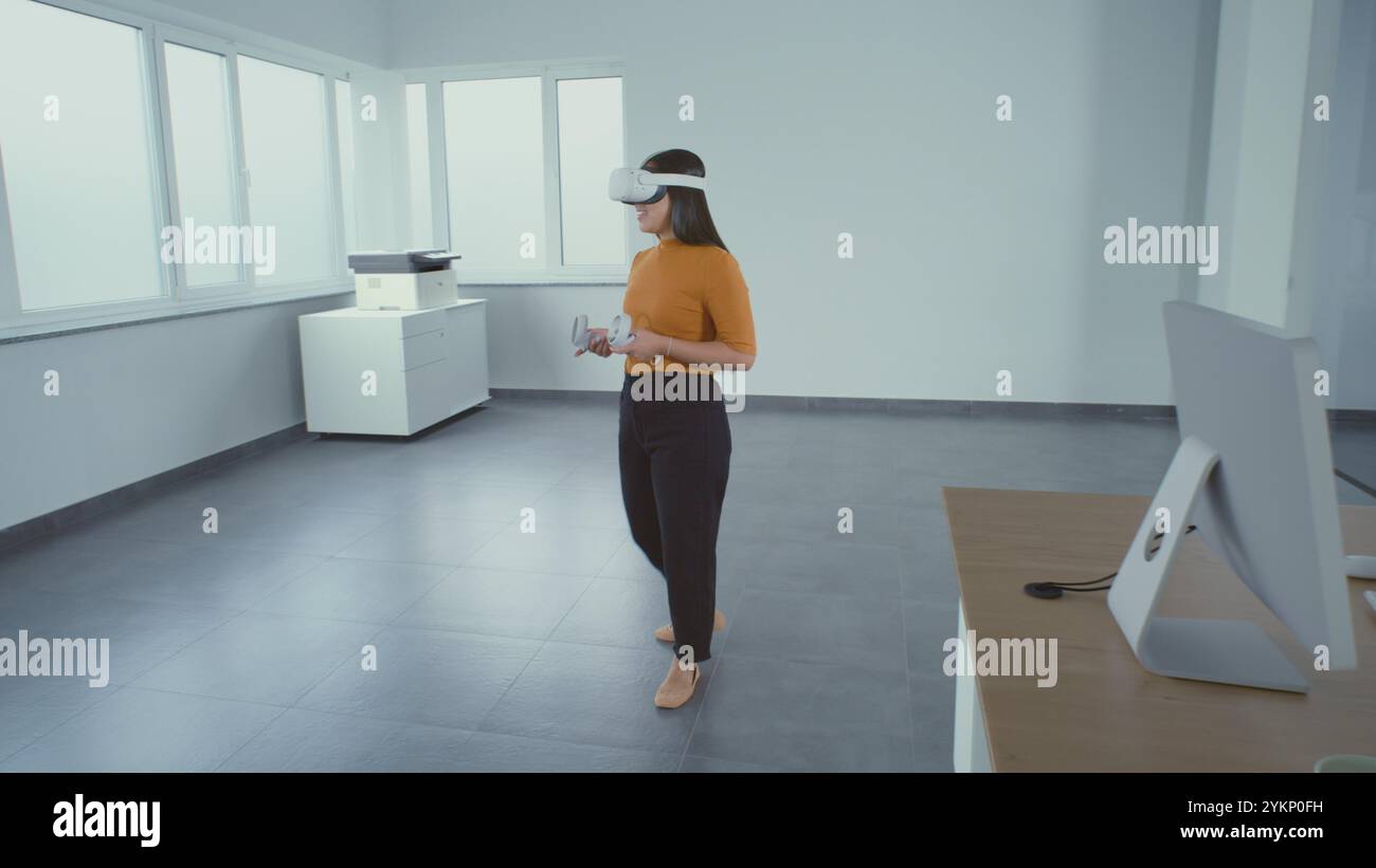 Creative Asian female designer wearing augmented reality headset uses ...