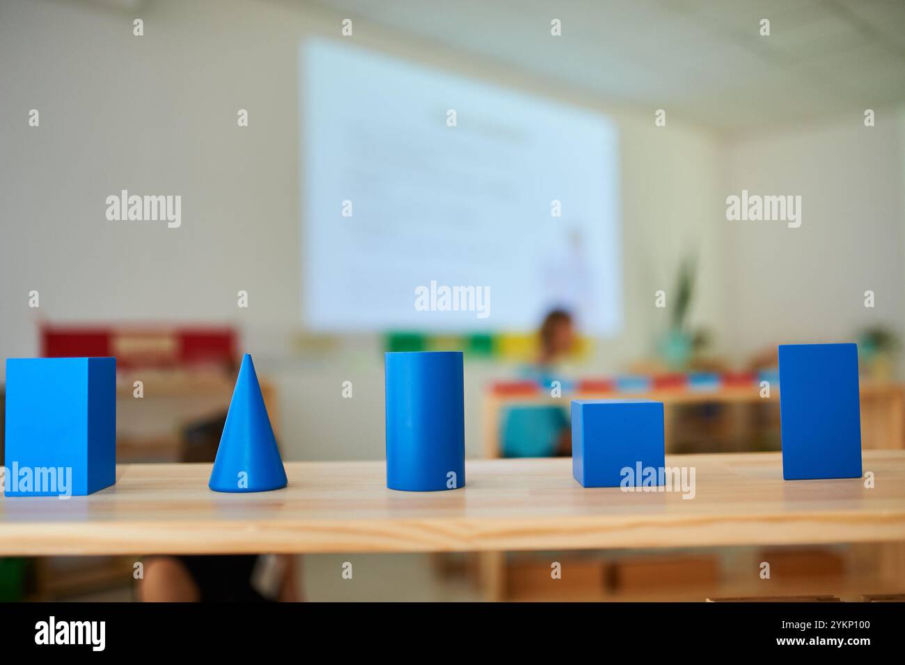 Montessori geometric solids in a preschool classroom. Bright blue ...